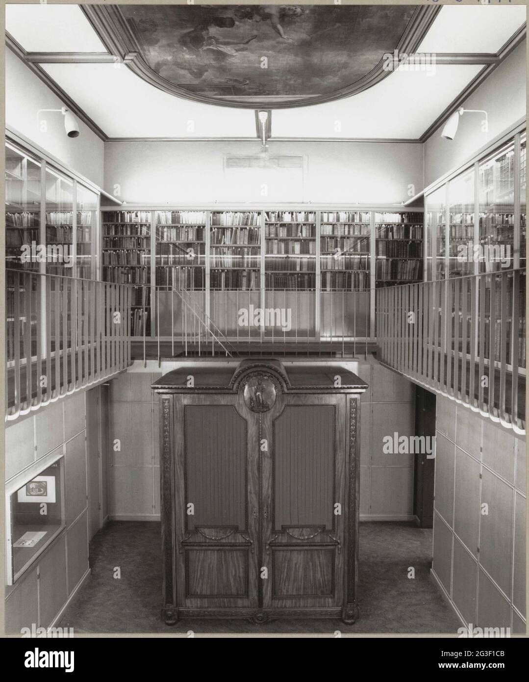 Entrance with wooden doors, gallery, bookcases and ceiling painting ...