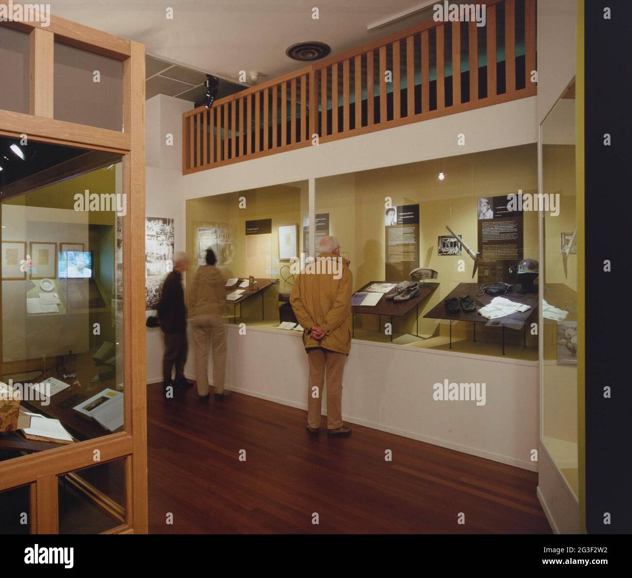 Corner of a room with showcases with various objects and visitors ...