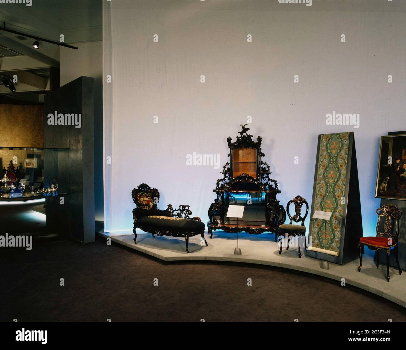 Display cabinet and a chaise longue in a seedroom style in a ...