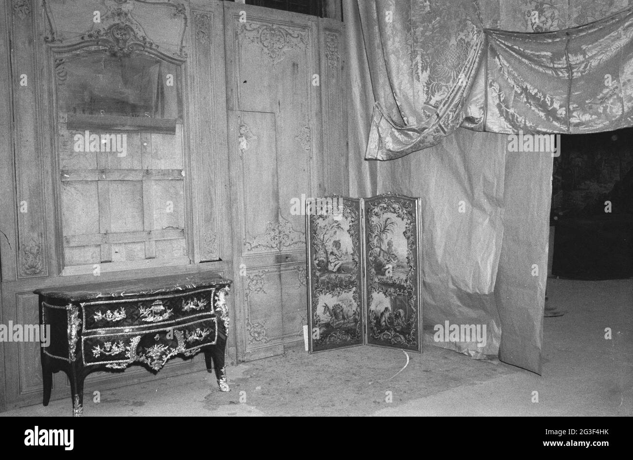 Paneling, changing table and room screen against a background of pieces ...