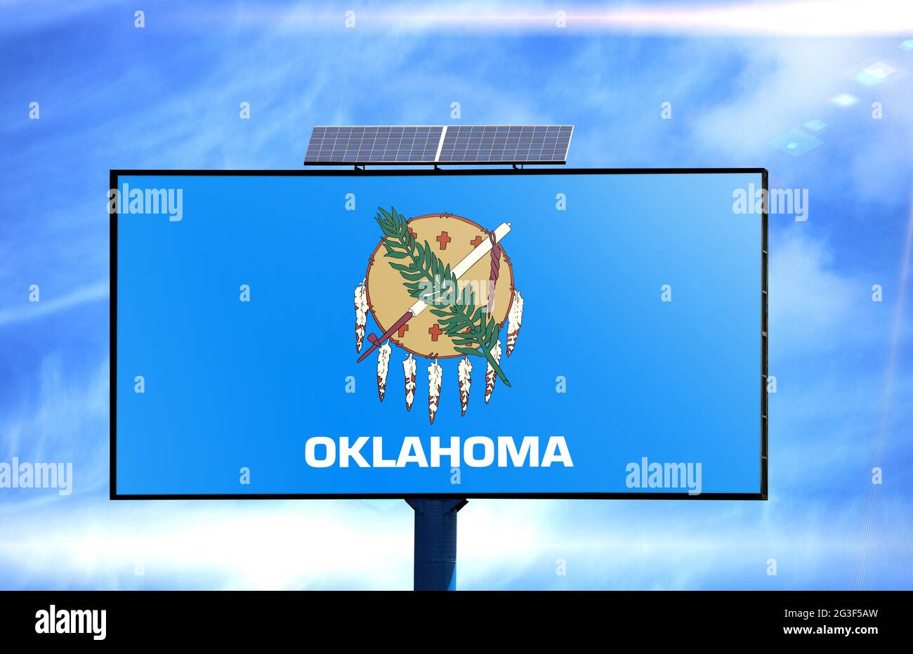 Billboard with State of Oklahoma flag and solar battery on blue sky ...