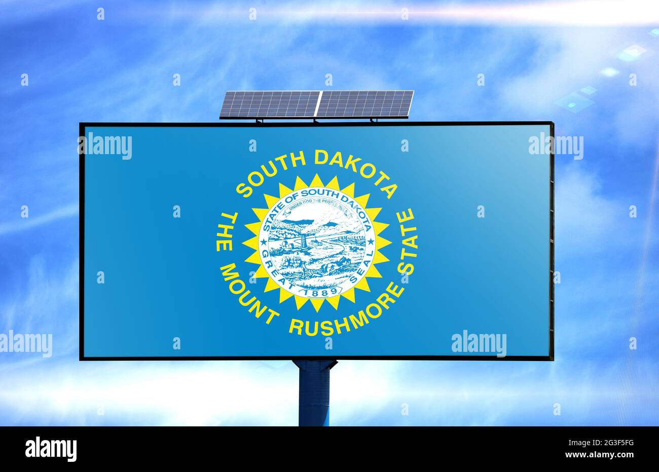 Billboard with State of South Dakota flag and solar battery on blue sky ...