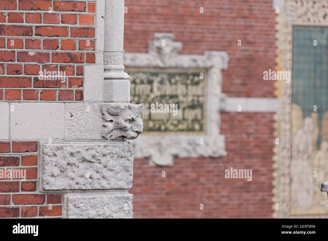 Sculpted head to a rain pipe to the exterior of the library with two ...