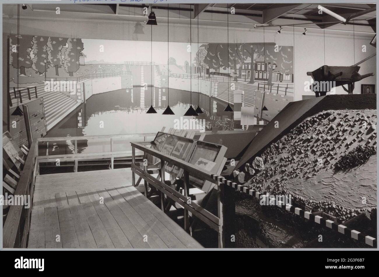 Room with hydraulic engineering and a wooden circulation, at the top ...
