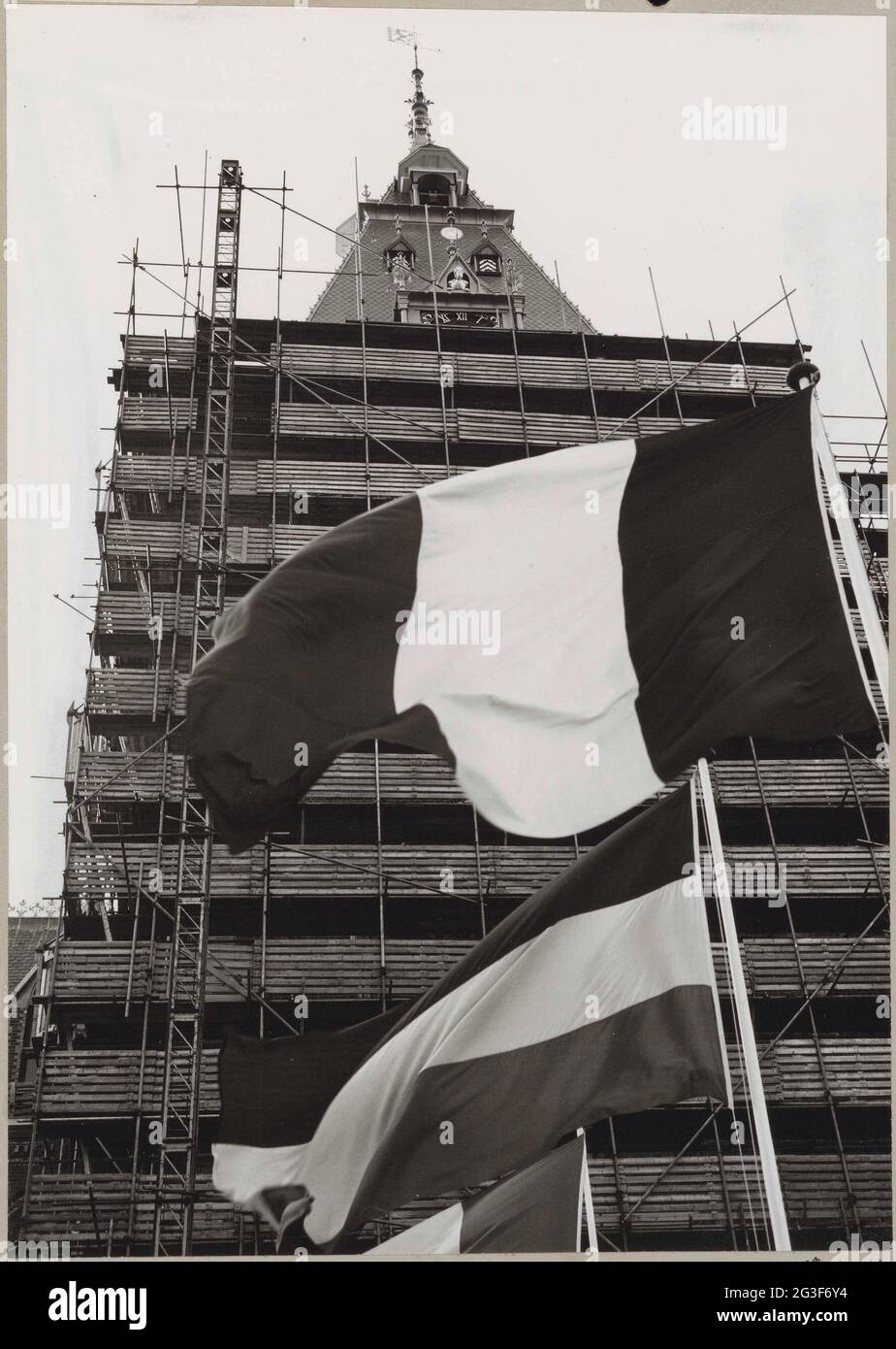 Clock tower in the scaffolding, three flags are visible at the bottom ...