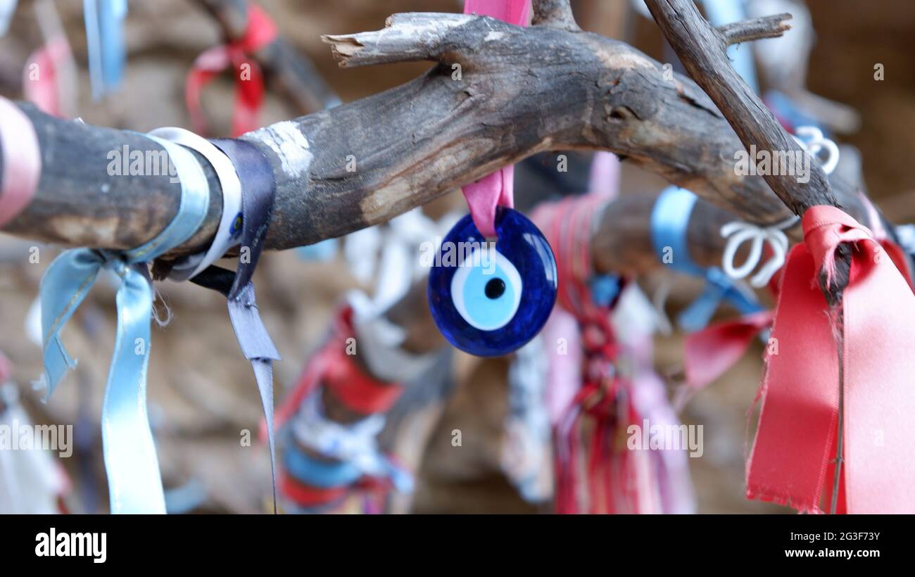 Evil eye bead, evil eye bead hanging on a tree Stock Photo - Alamy