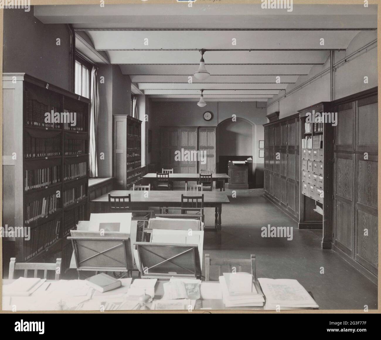 Reading room of the print cabinet with tables on the left and bookcases ...
