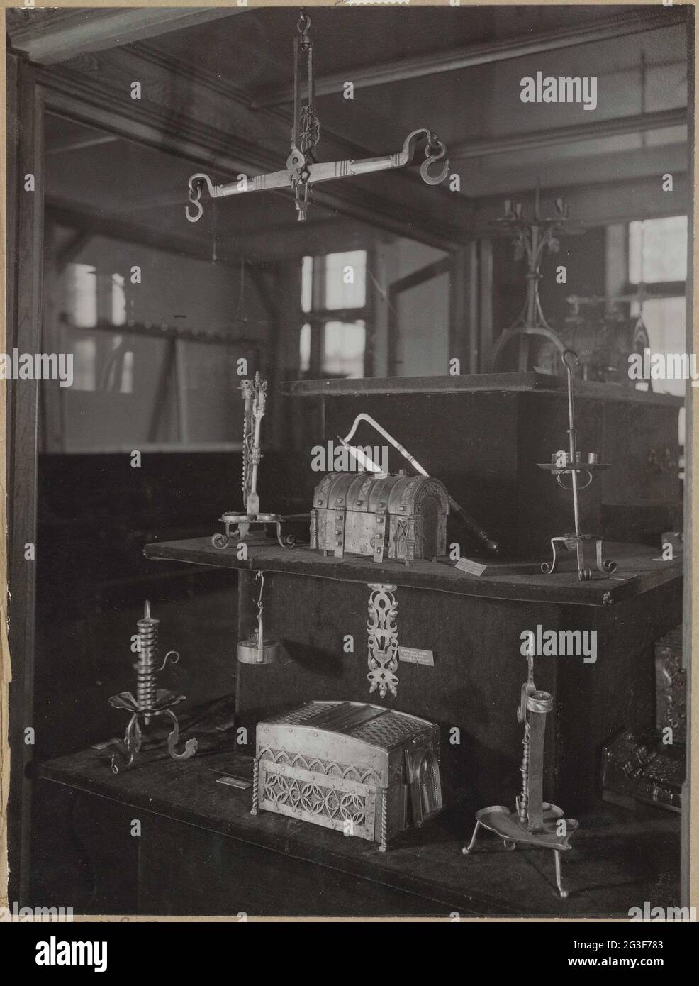Showcase with metal objects including crates, referred to as iron tray ...