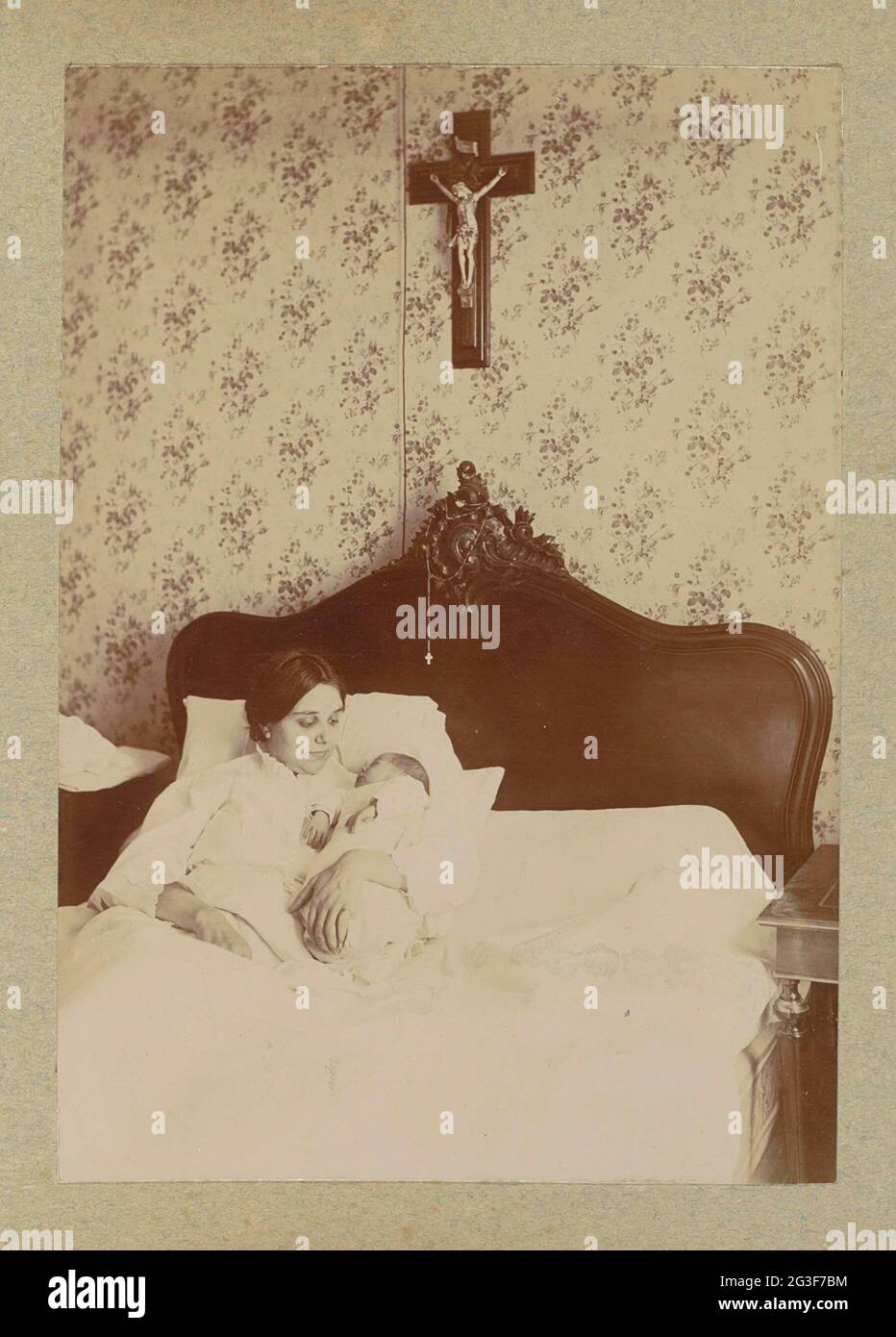 Mother with a baby in a maternity bed. Part of photo album with family ...