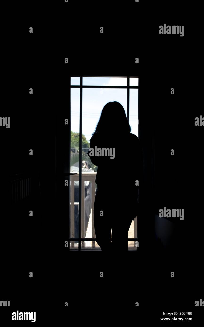 Dramatic Capture of a friend looking out a window Stock Photo - Alamy