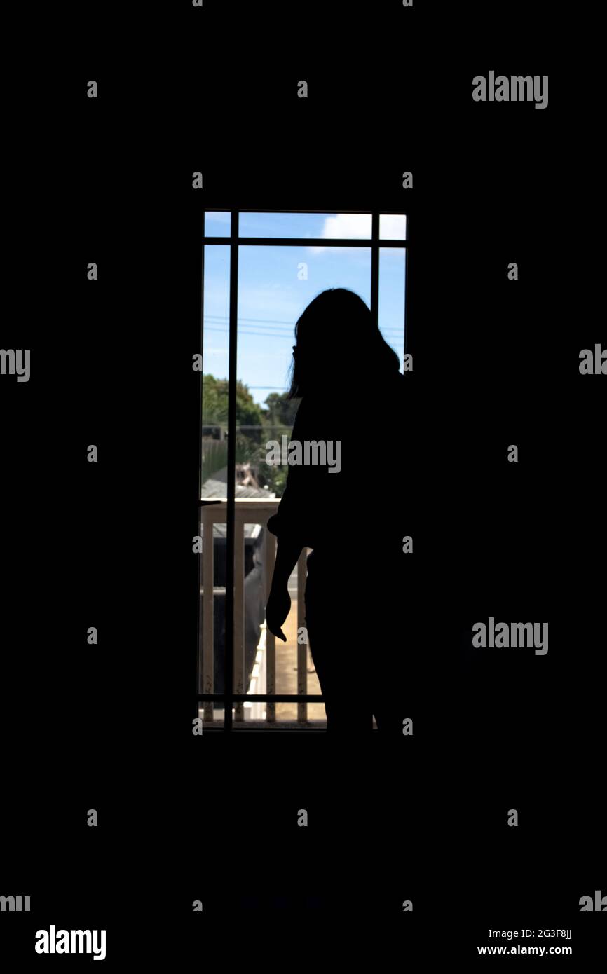 Dramatic Capture of a friend looking out a window Stock Photo - Alamy