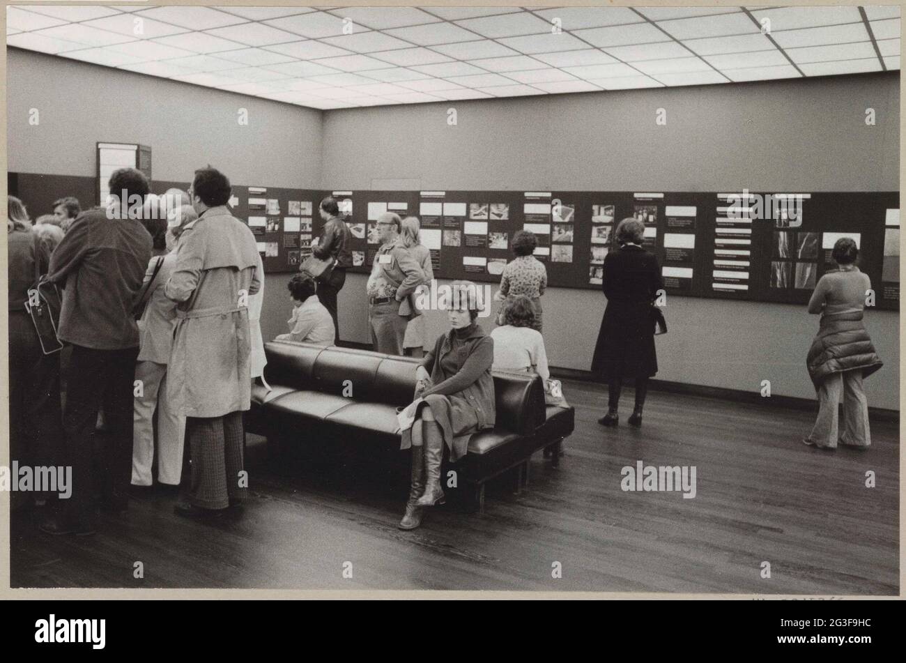 Room with information panels on the wall and visitors; Educational ...
