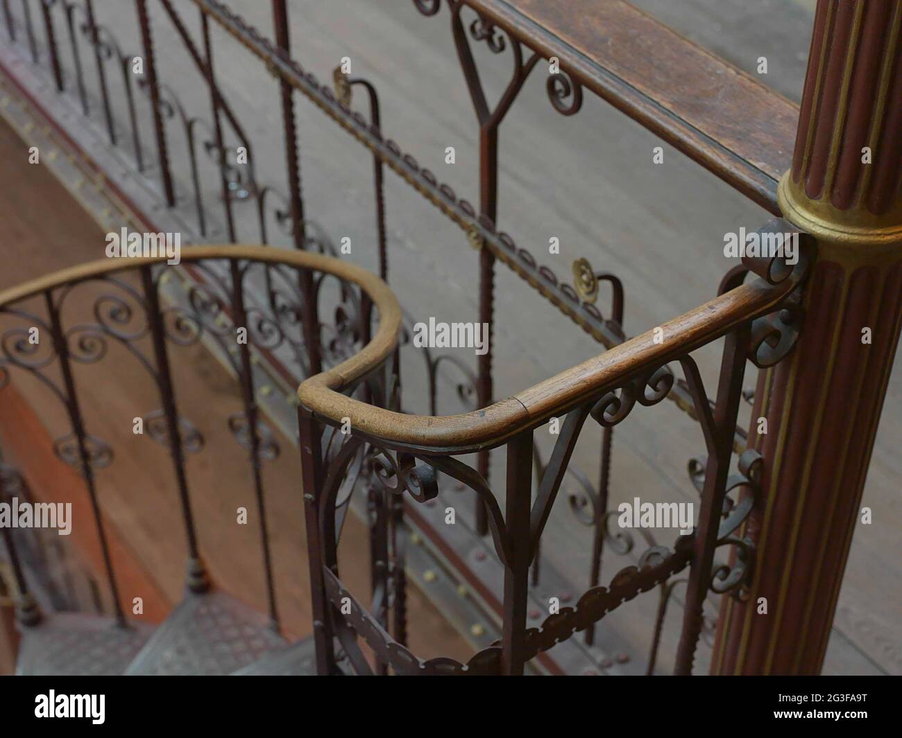 Detail cast iron column, balustrade with a wide oak shelf and spiral ...