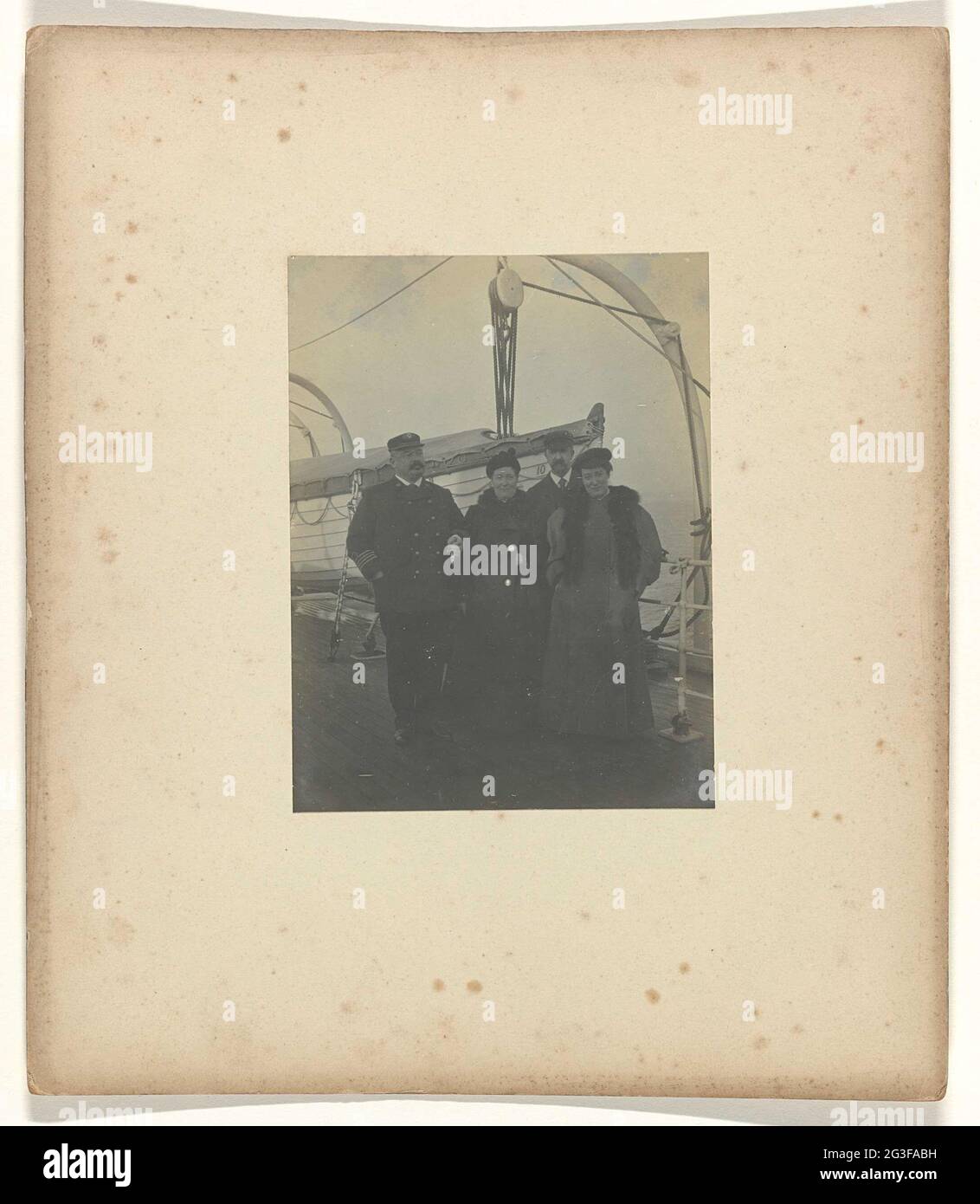 Group portrait of two men and two women on the deck of a ship. Group ...