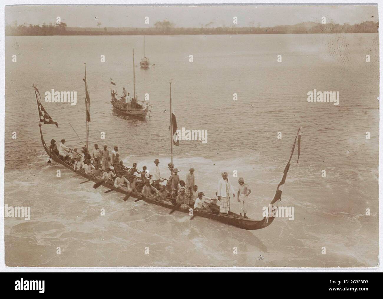 A rowing path with locals alongside of a steamship in Indonesia Stock ...