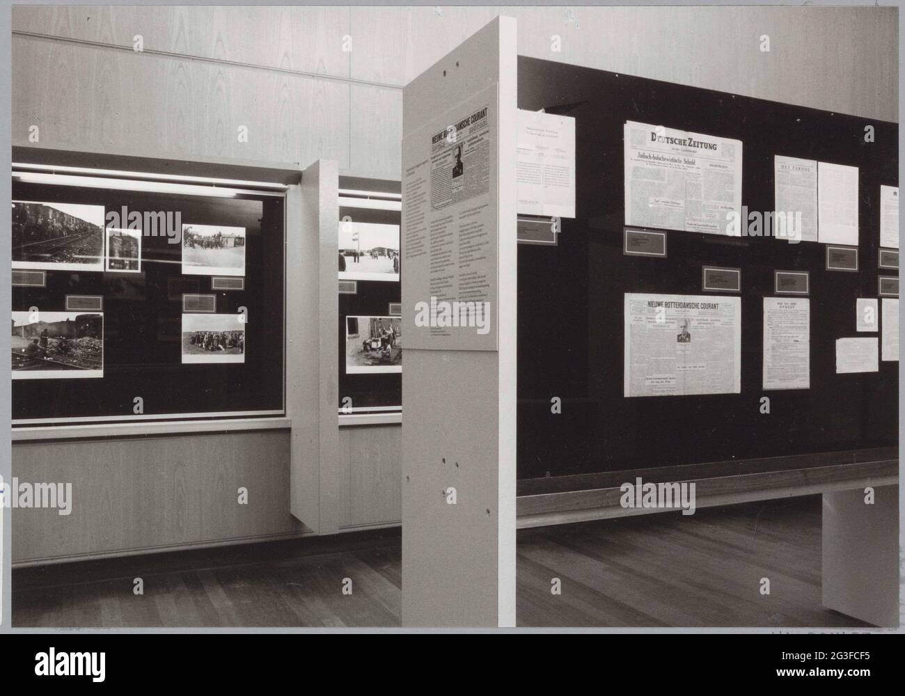 Room with photos and newspaper articles in showcases; Exhibition ...