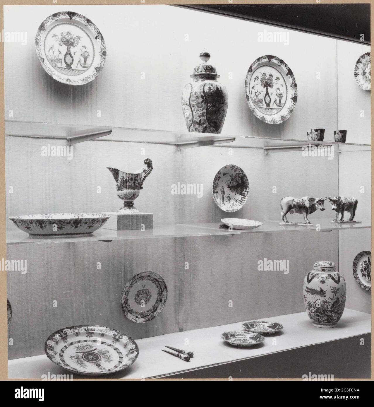 Showcase with objects of ceramics including dishes, pots and images of ...