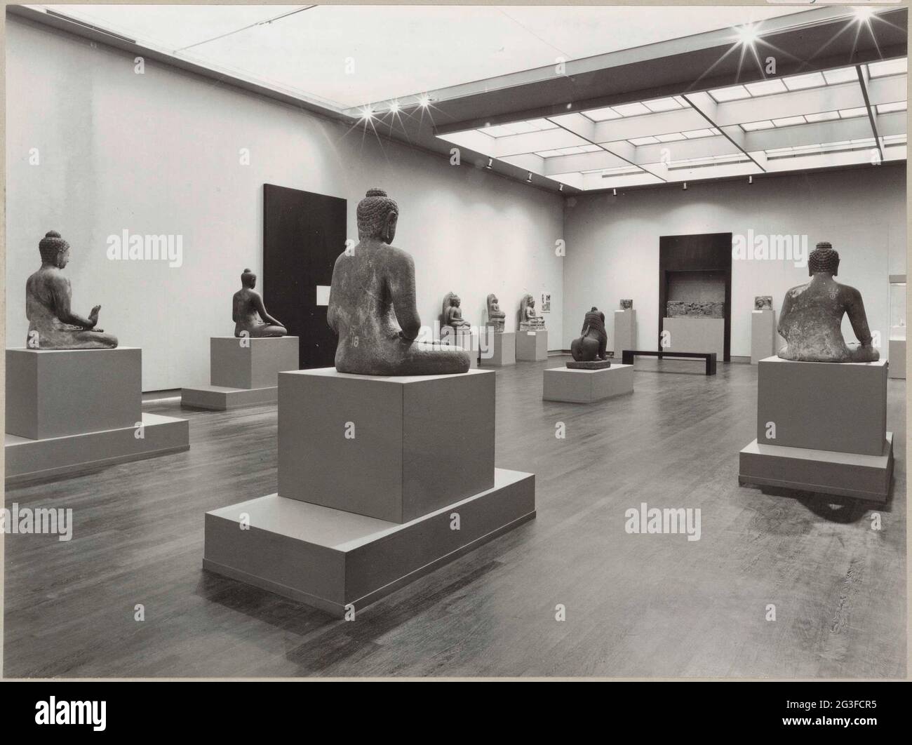 Room with images including four Buddha statues on pedestals, a lion ...