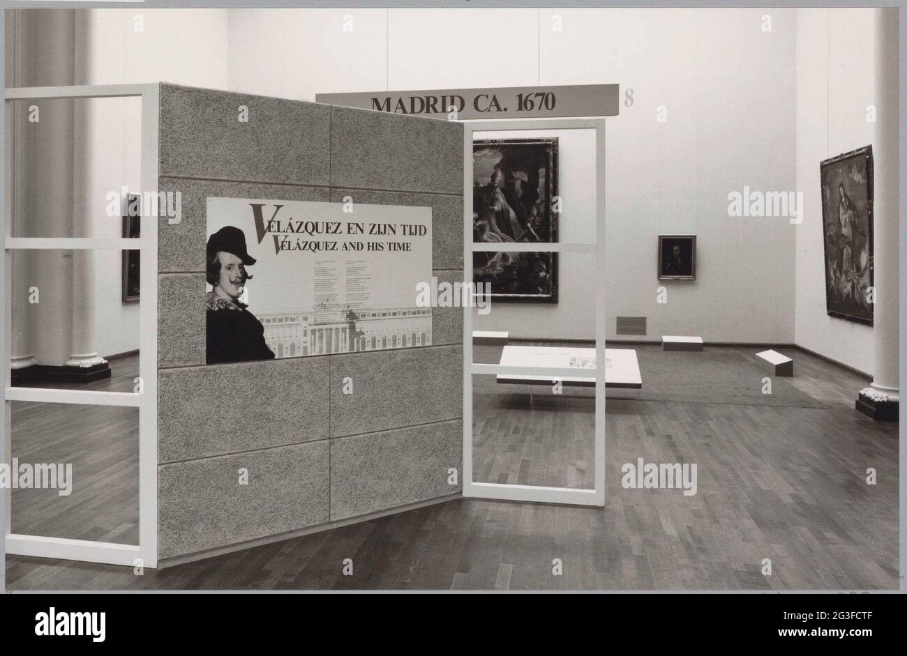 Panel with the exhibition title at the entrance and view of a cabinet ...