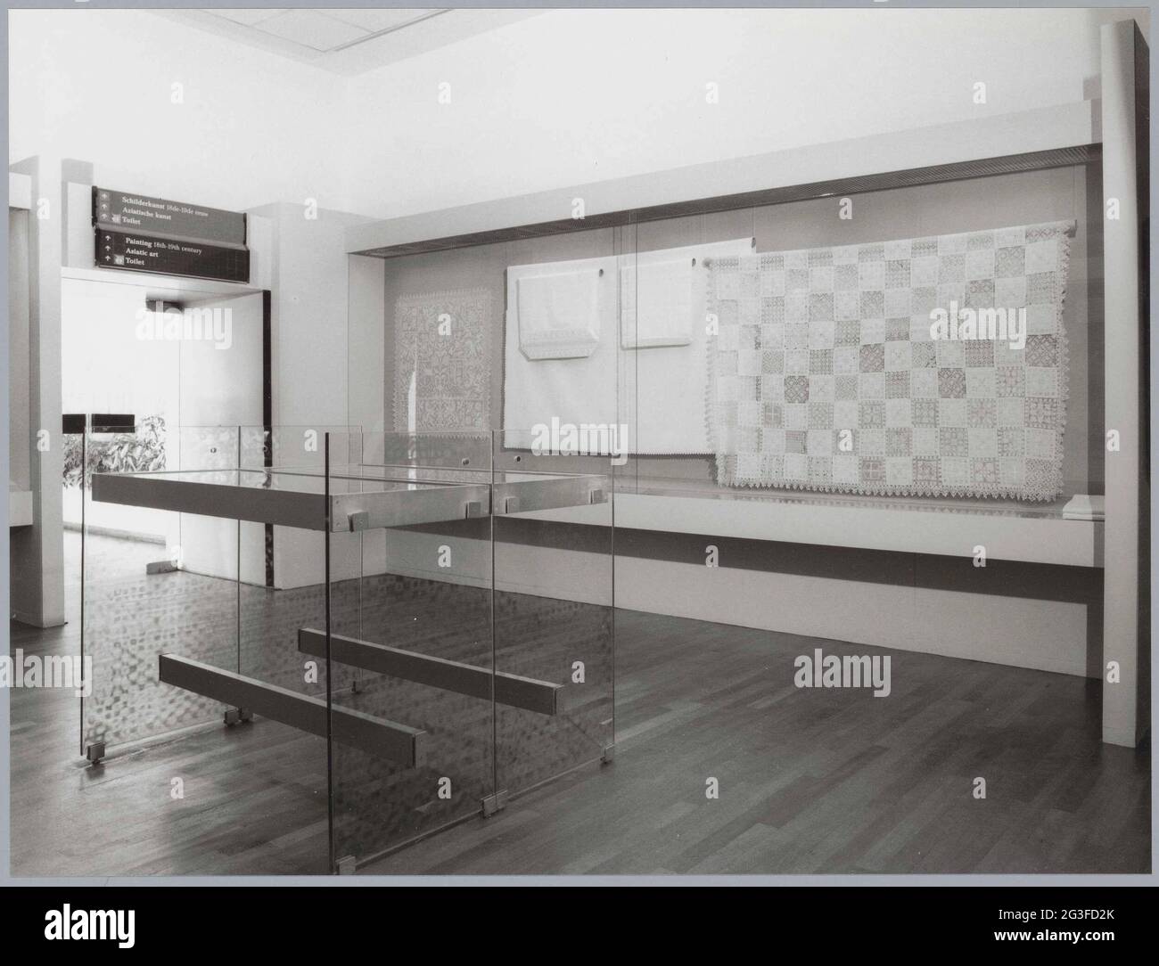 Room with lace objects in showcases, links a passage; Lace arrangement ...