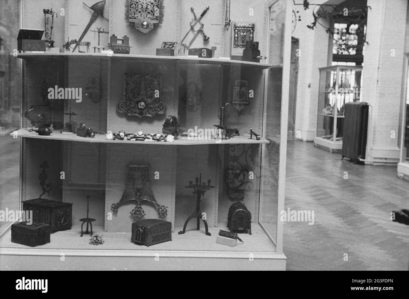 Angle of a room with painting, table and display cases with various ...