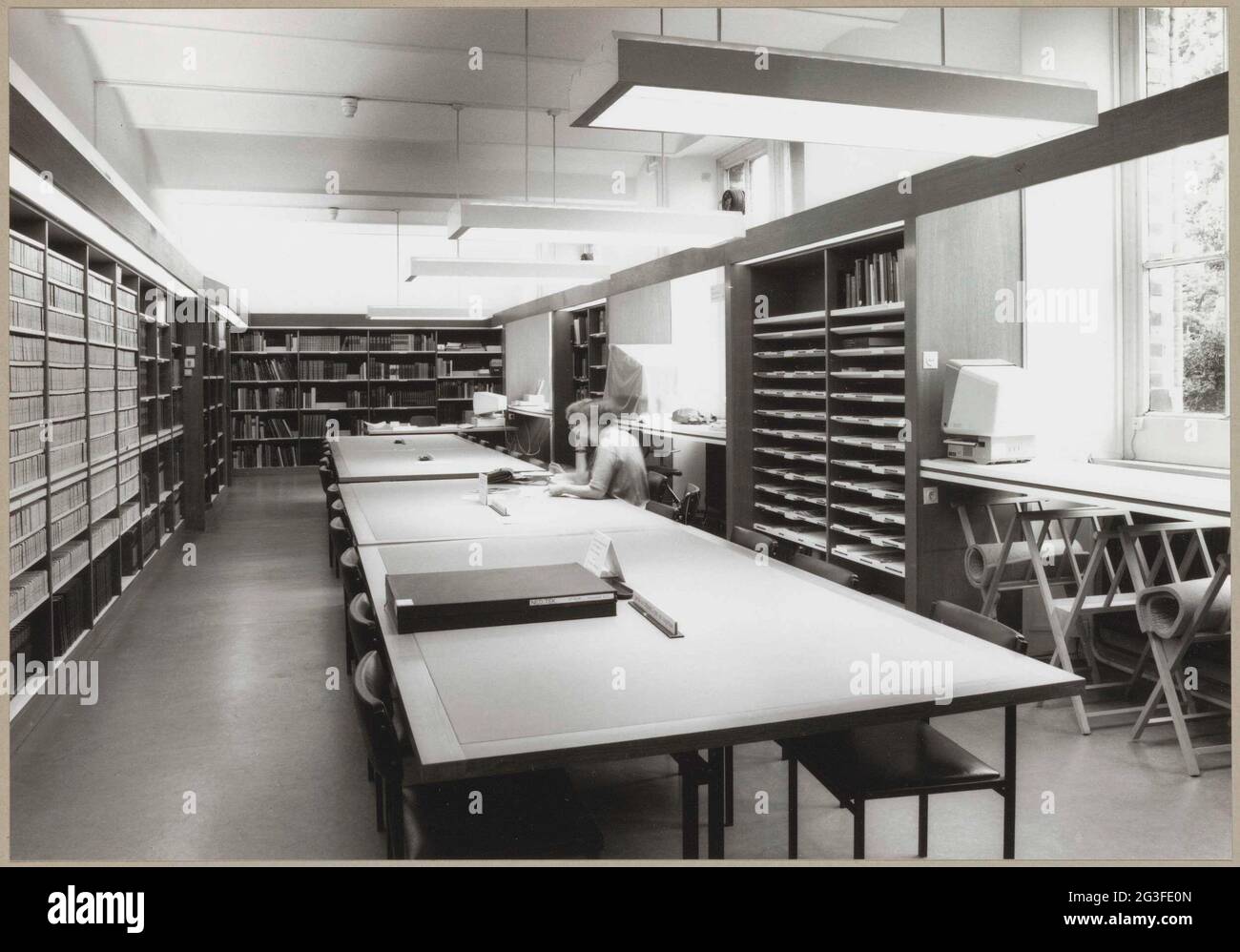 Space with cupboards, tables, people and picture standards; Interior ...
