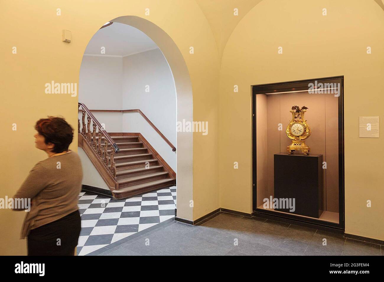 Visitor in the hall of the Philips wing with a wall clock in vitrogen ...