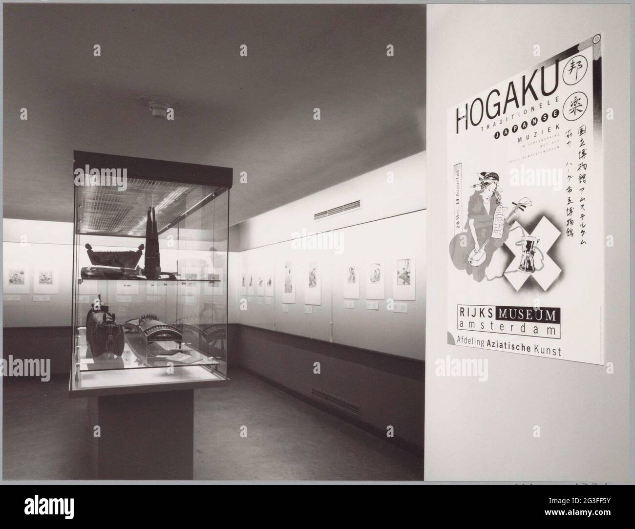 Room with prints and musical instruments in showcases and in the ...