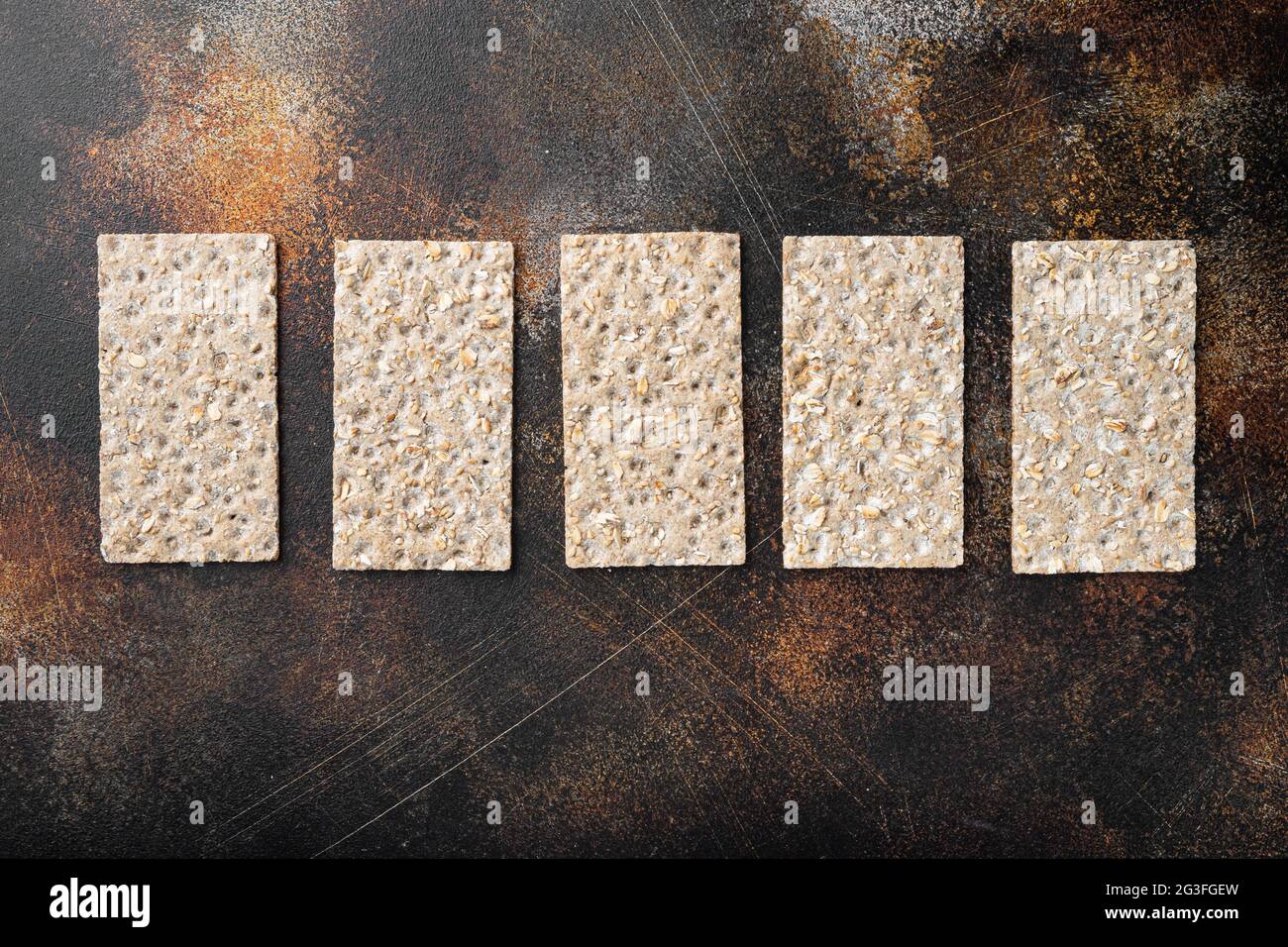 Whole grain crisp bread set, on old dark rustic table background, top ...