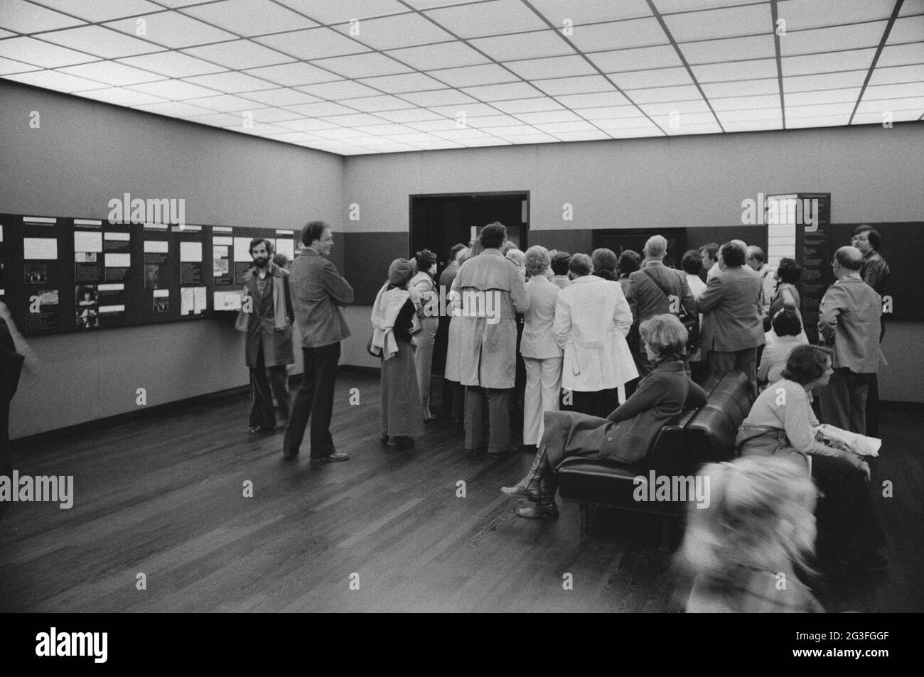 Room with information panels on the wall and visitors; Educational ...