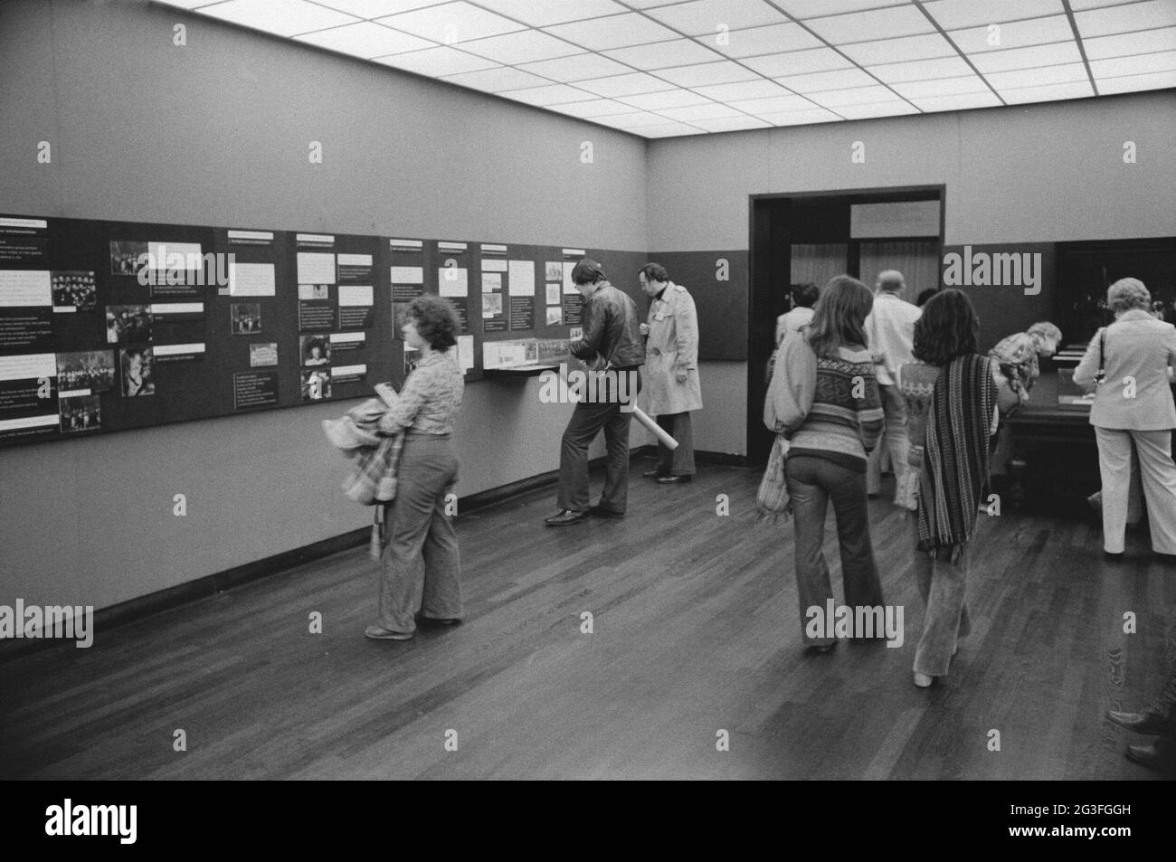 Room with information panels on the wall and visitors; Educational ...