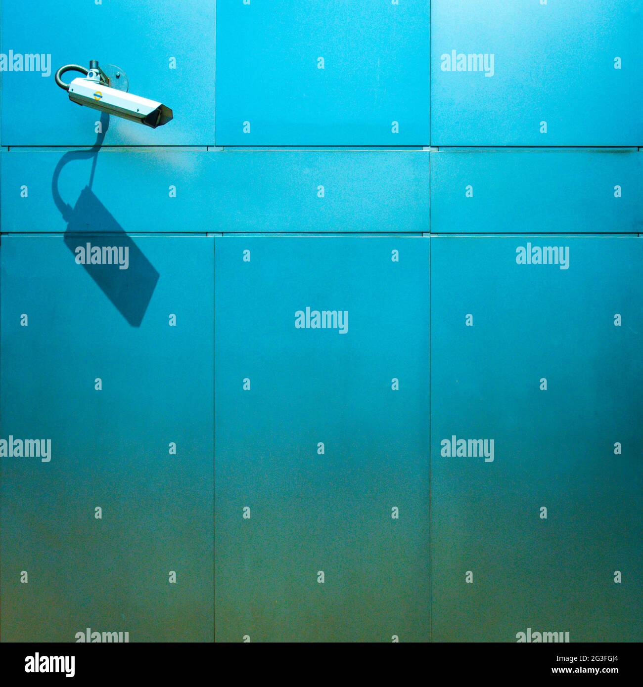 CCTV Camera on Blue Wall Stock Photo - Alamy