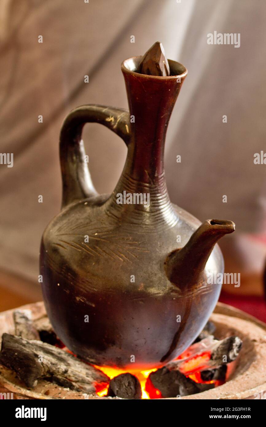 Brewing coffee with Jebena using coal Stock Photo - Alamy