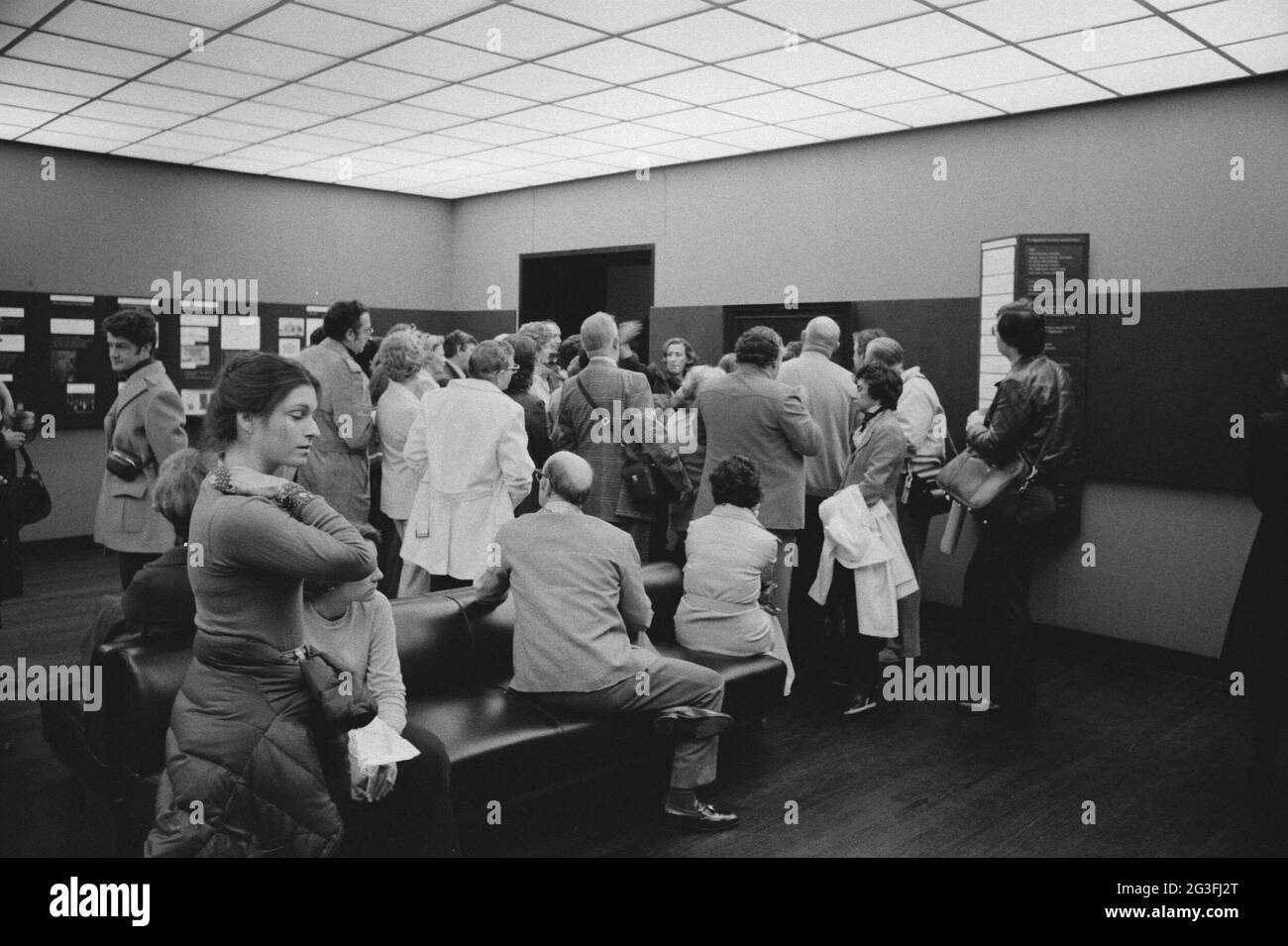 Room with information panels on the wall and visitors; Educational ...