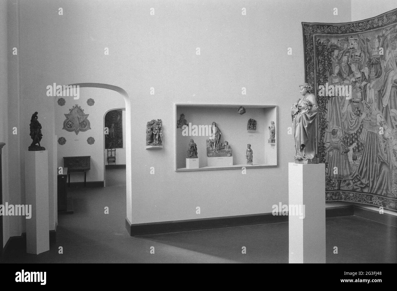 Room with images, tapestry, display case and passage; Interiors West ...