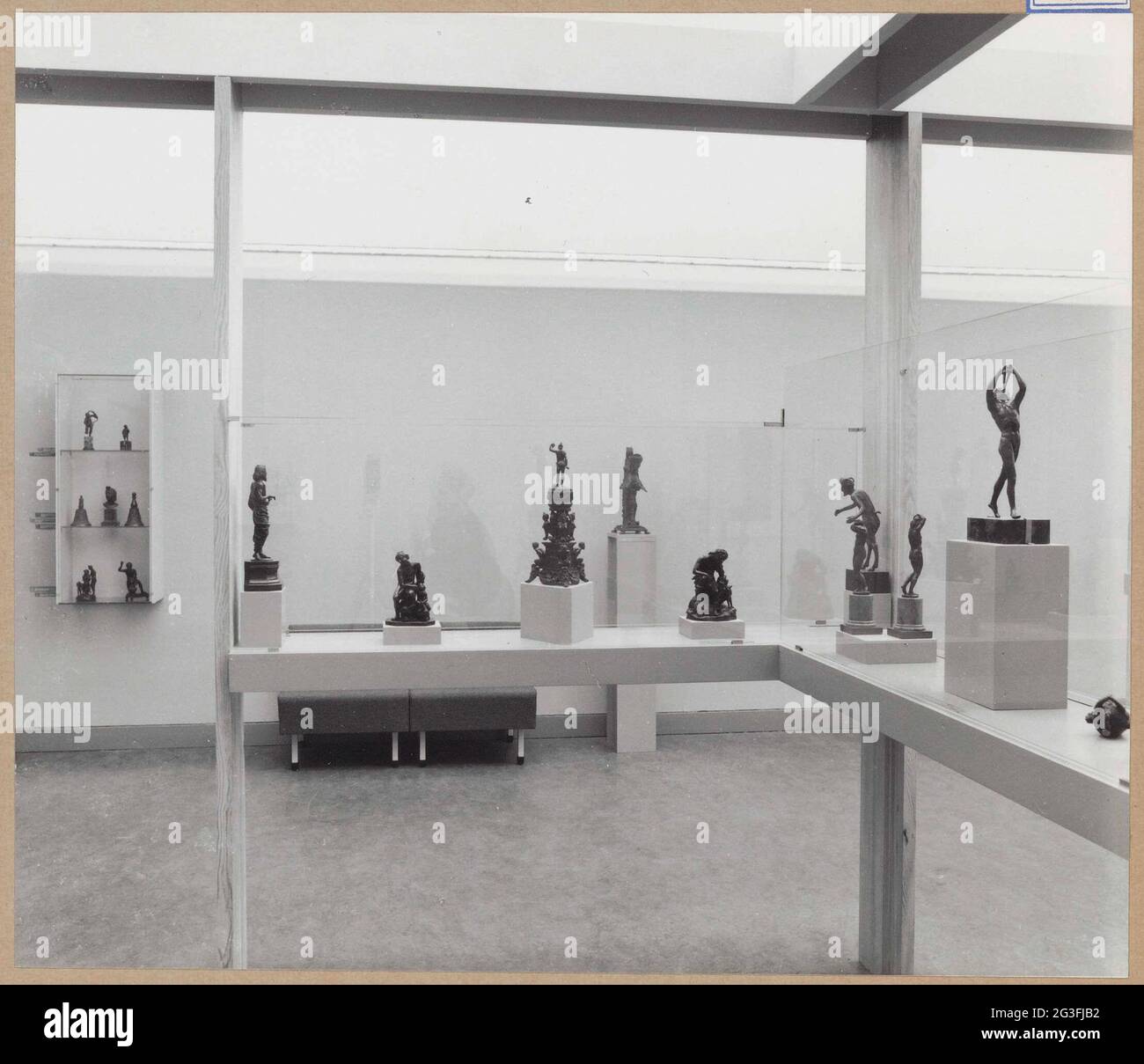 Room with a base, wall vitrain and 3-legged display with bronze ...