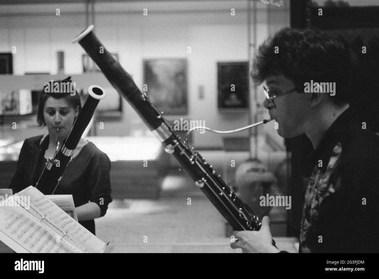 Standing woman and a man playing wind instruments; Music weekend Stock ...