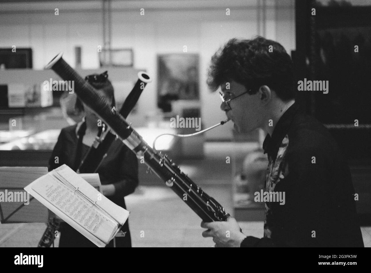 Standing woman and a man playing wind instruments; Music weekend Stock ...