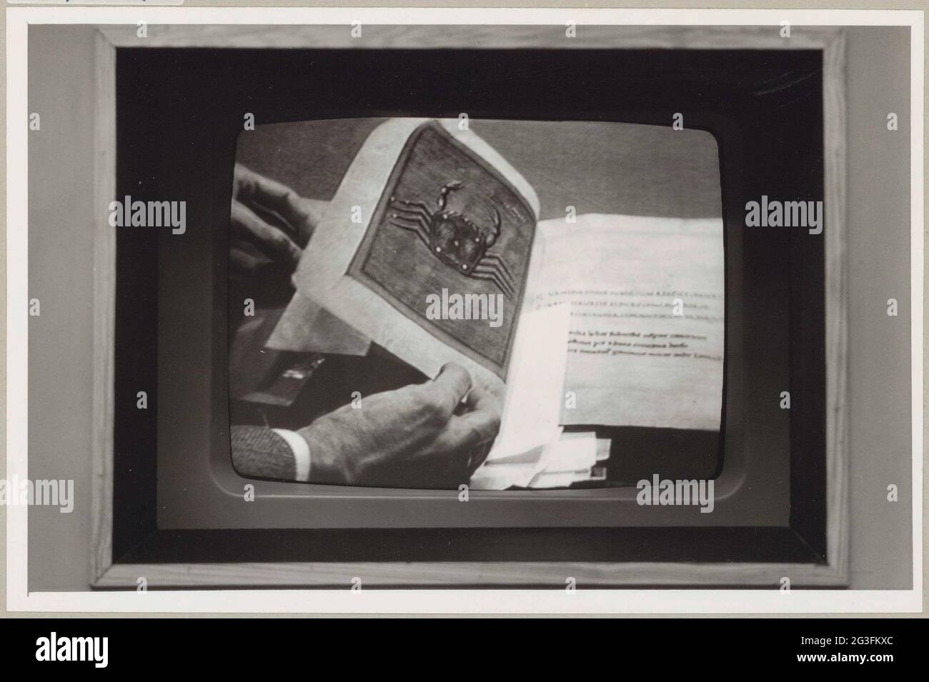 Television screen with a hand scrolling through a book; Leiden ...