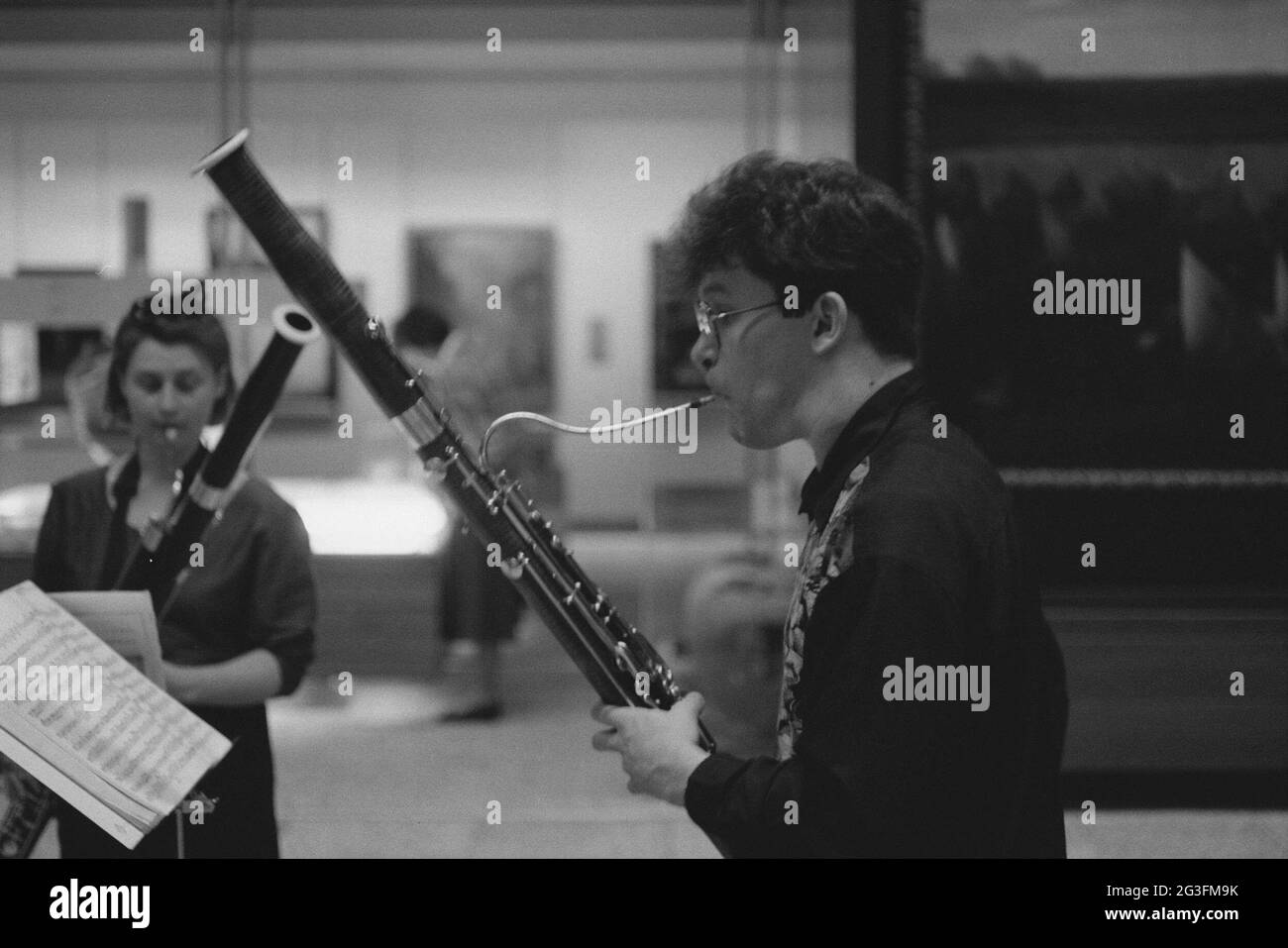 Standing woman and a man playing wind instruments; Music weekend Stock ...