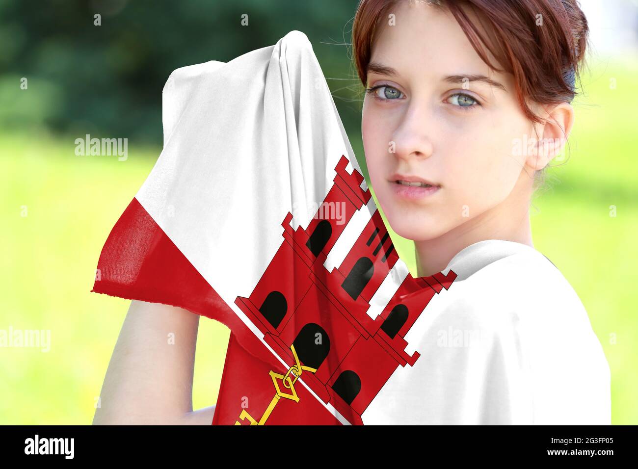 Young girl holding the flag of Gibraltar close up Stock Photo - Alamy