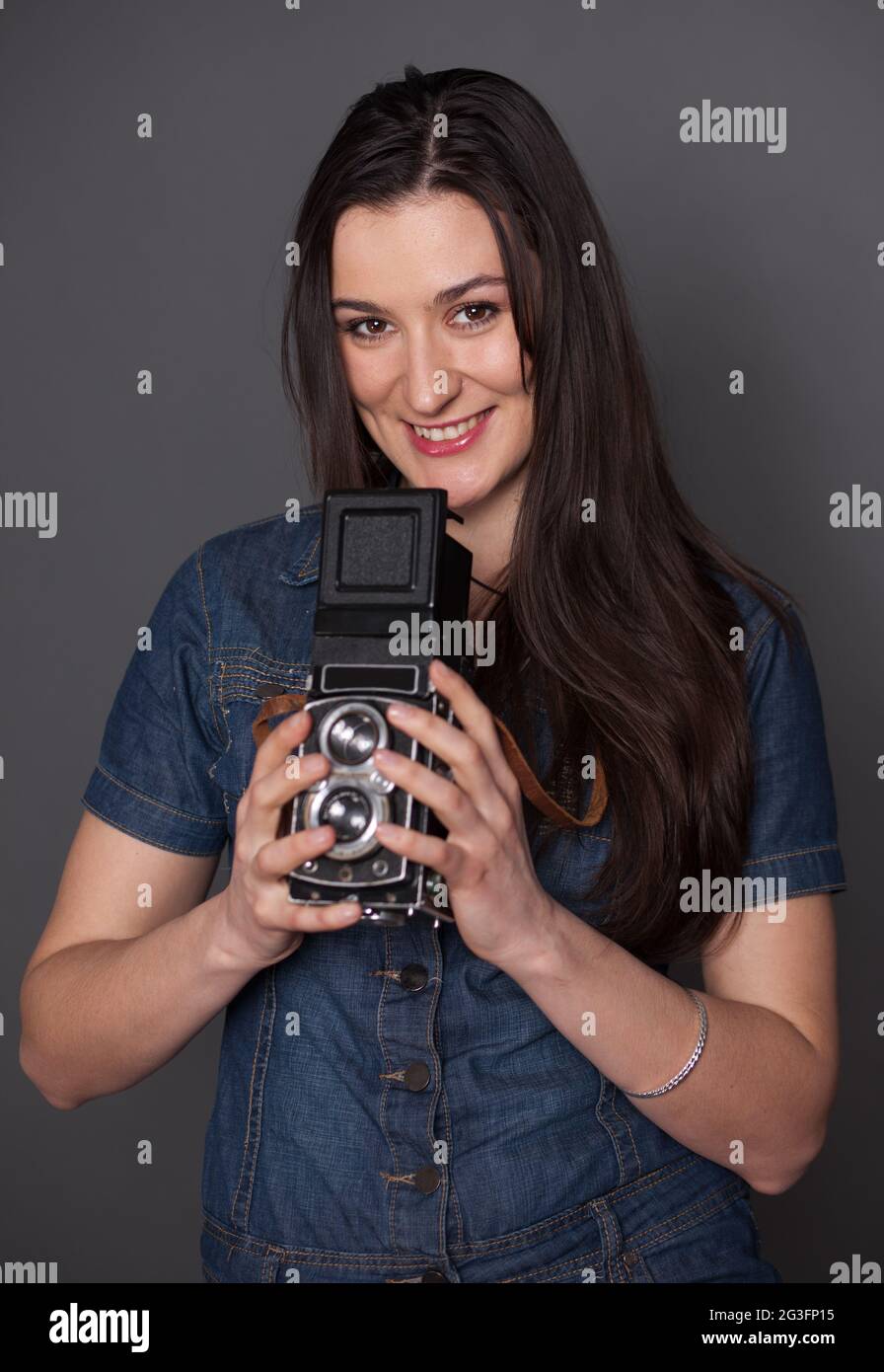 Beautiful woman with film camera Stock Photo - Alamy
