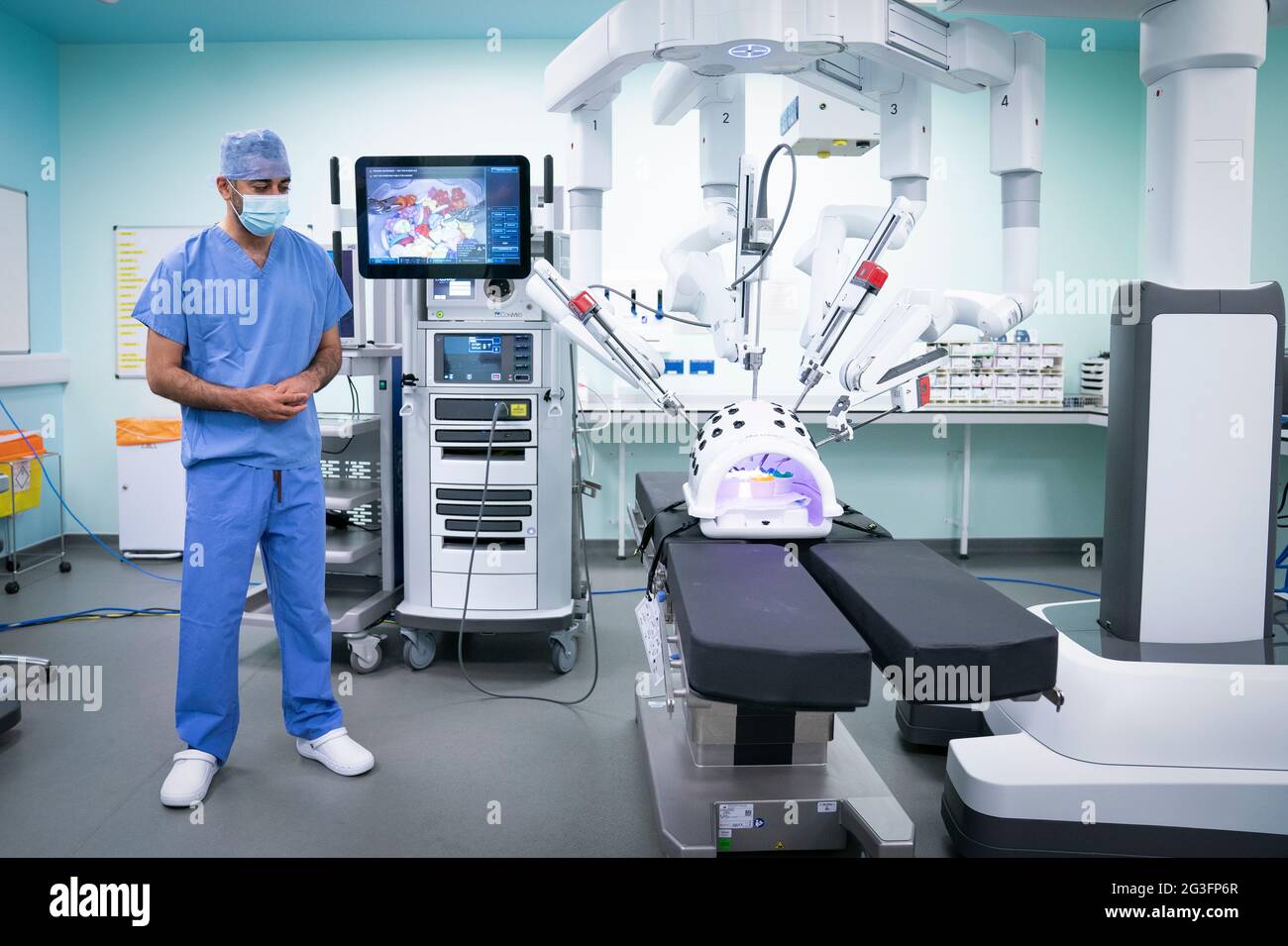 Health Secretary Humza Yousaf watches a surgical robot at work at ...