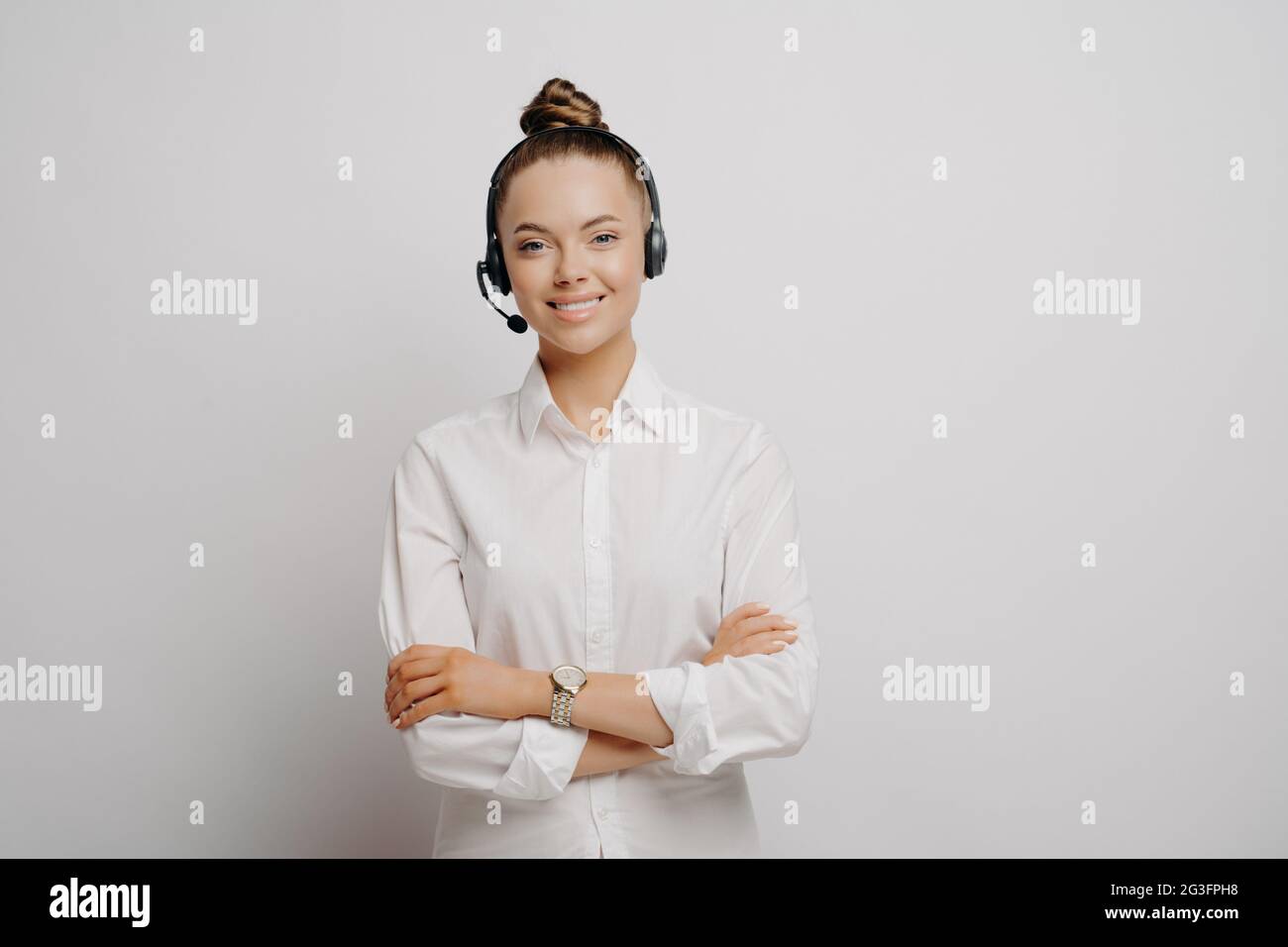 Young female employee in headphones hi-res stock photography and images ...