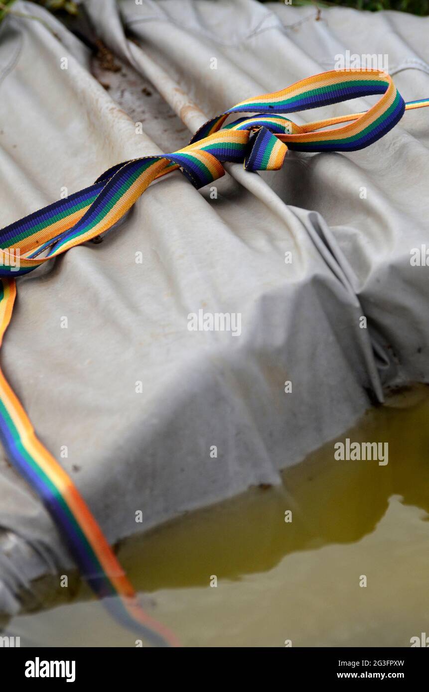 striped strap on water filled dinghy storage cover Stock Photo - Alamy