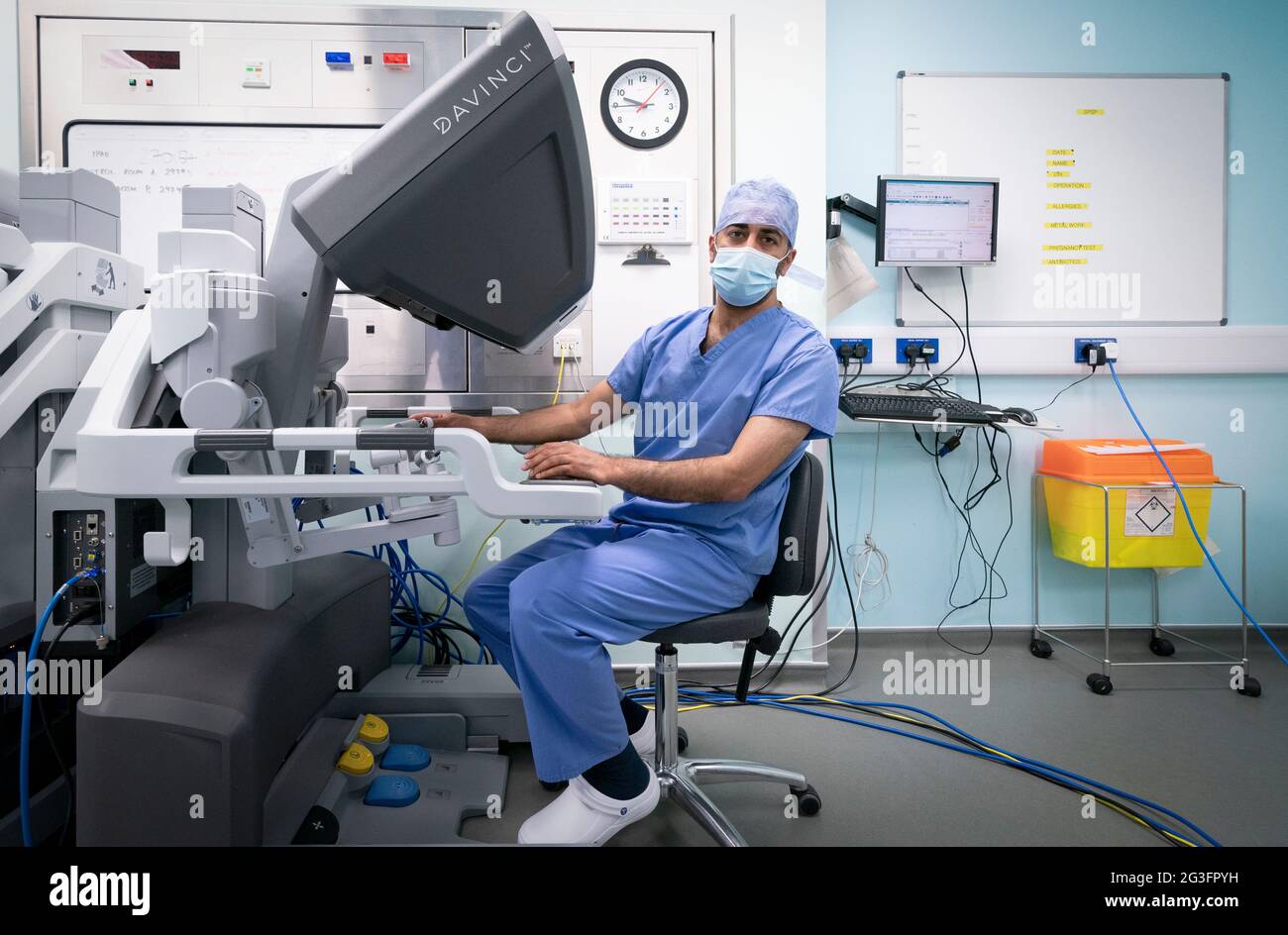 Health Secretary Humza Yousaf operates a surgical robot during a visit ...