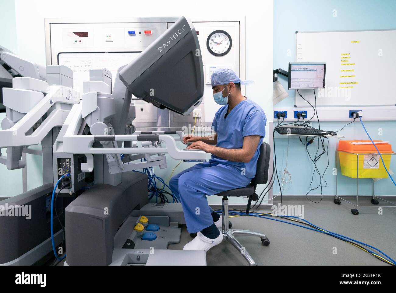 Health Secretary Humza Yousaf operates a surgical robot during a visit ...