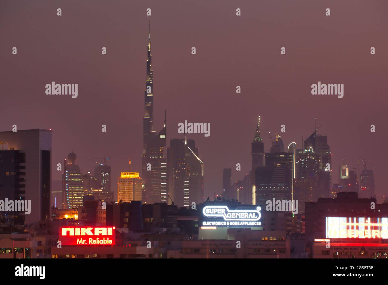 The skyline of the business district of Dubai, the UAE by night with ...