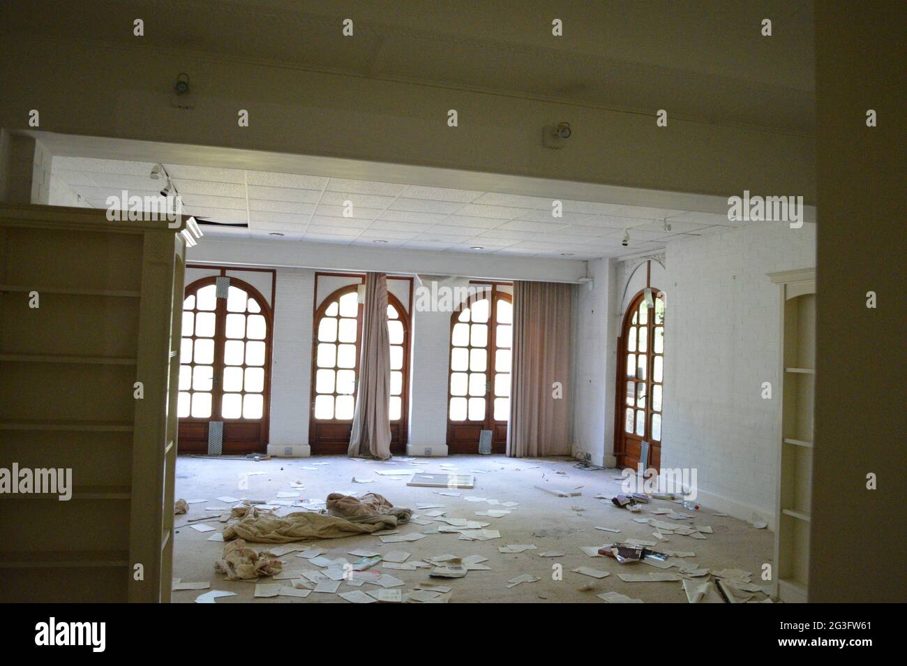 Papers are scattered across one of the mansion's multiple living rooms ...