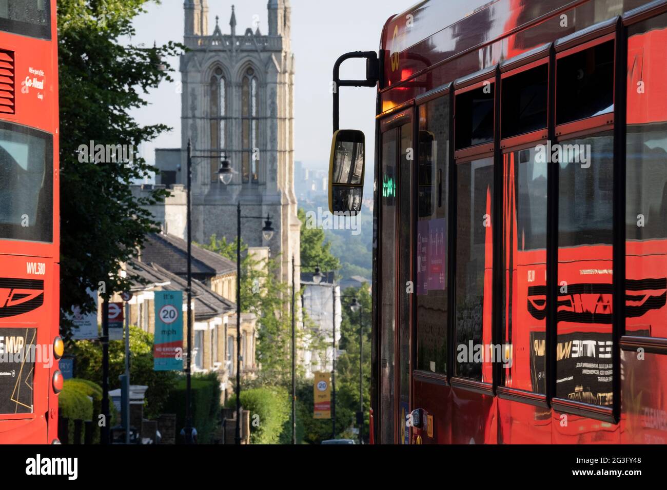 With the London skyline in the far distance, a bus descends towards ...